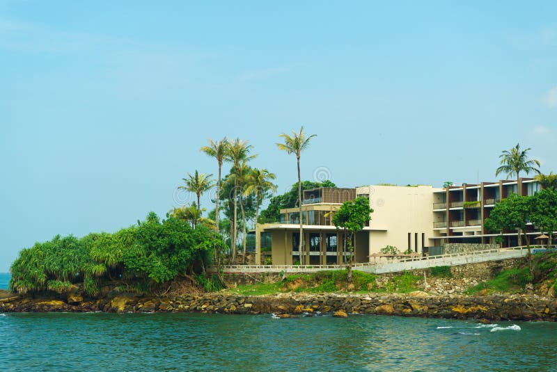 Hotel with Palm Trees on a Rocky Ocean Shore Editorial Photography ...