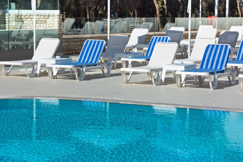 Hotel Poolside Chairs Near a Swimming Pool Stock Image - Image of ...
