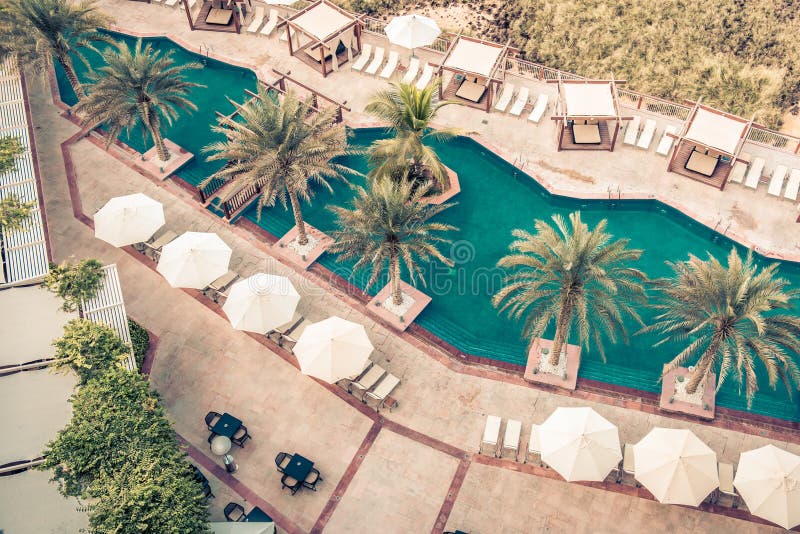 Hotel Poolside with Parasols and Palms Stock Photo - Image of scene ...