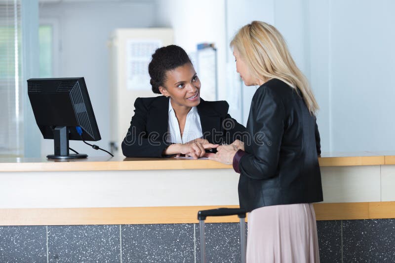 Hotel Receptionist Doing Check-in for Customer Stock Photo - Image of ...