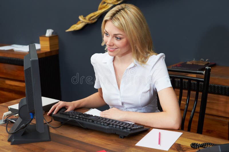 Hotel Receptionist Using Computer and Phone Stock Image - Image of ...