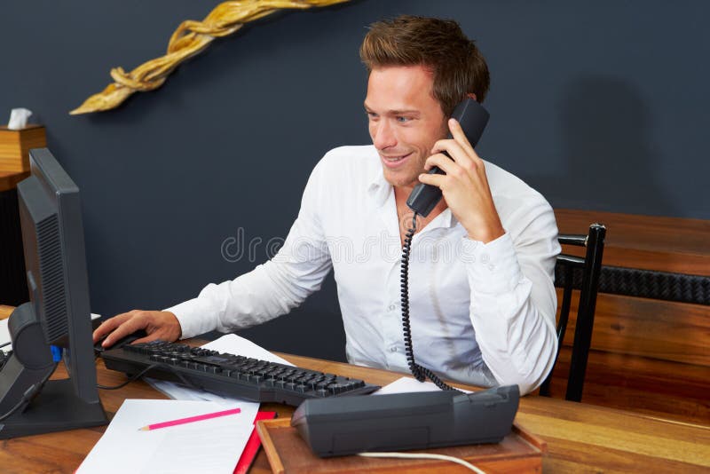 Hotel Receptionist Working at Computer Stock Image - Image of hotel ...