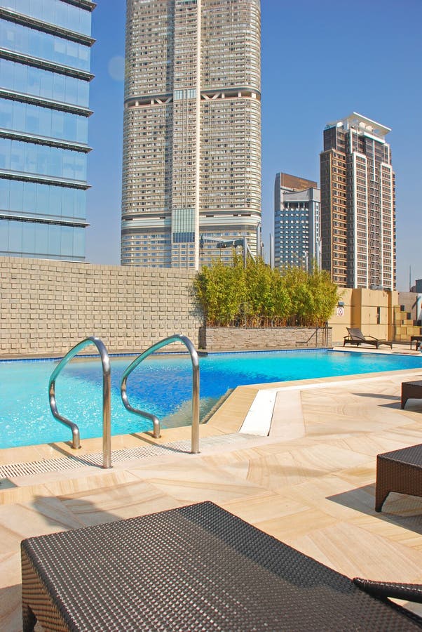 Hotel Rooftop Swimming Pool with Deckchair Stock Image - Image of brown ...
