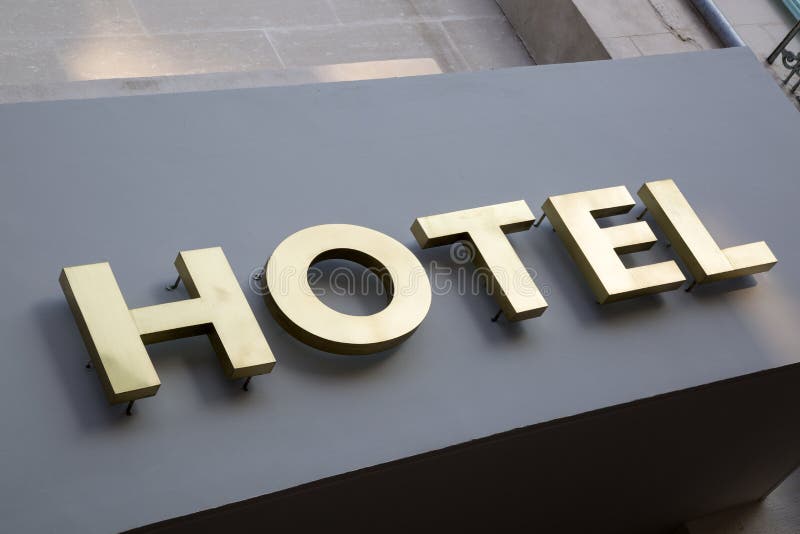 Gold Hotel Sign on White Wall Background Stock Photo - Image of ...