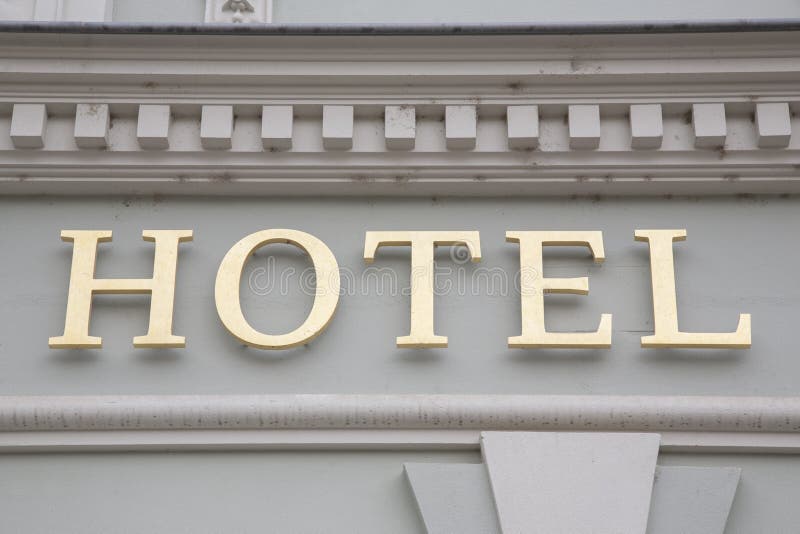 Gold Hotel Sign on White Wall Background Stock Photo - Image of ...