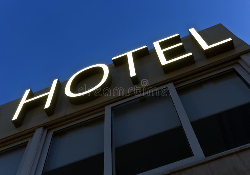 Hotel Sign Glowing Neon Letters on Top of a Building at Night Stock ...