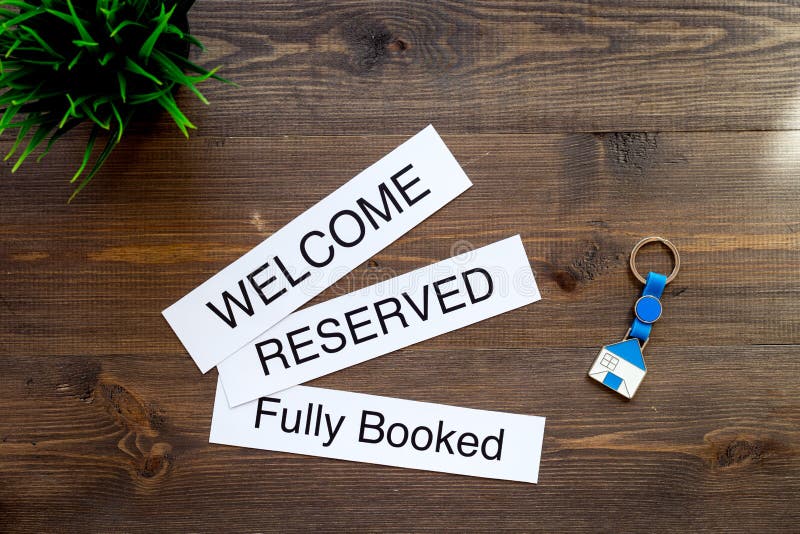 At the Hotel. Words Welcome, Fully Booked, Reserved on Dark Wooden ...