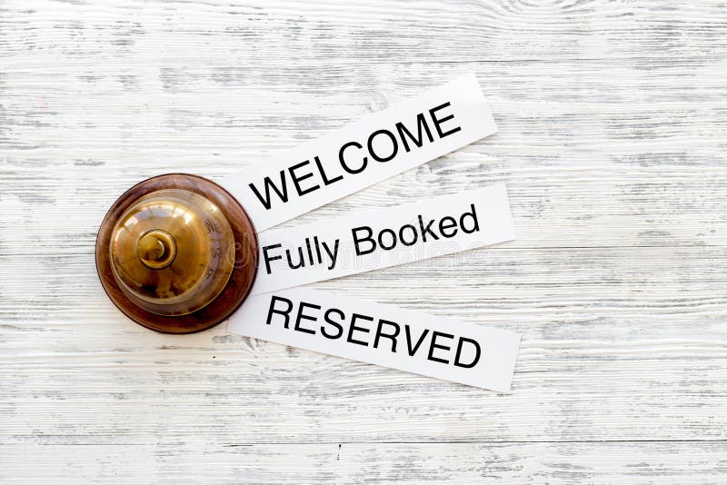 At the Hotel. Words Welcome, Fully Booked, Reserved on Light Wooden ...