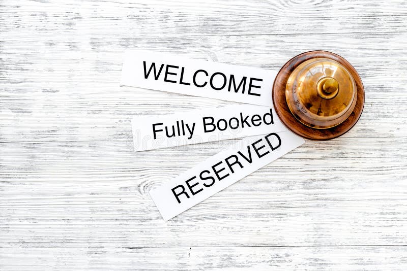 At the Hotel. Words Welcome, Fully Booked, Reserved on Light Wooden ...
