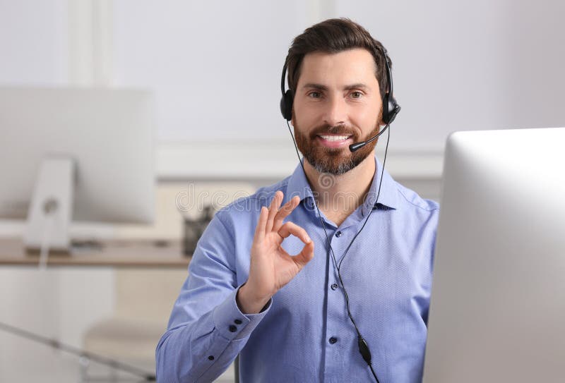 Hotline Operator with Headset Showing OK Gesture in Office, Space for ...