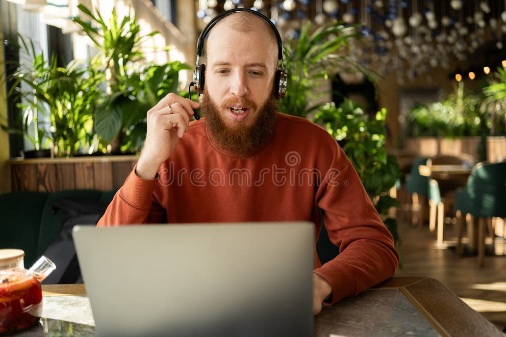 A Hotline Operator Working in a Cafe Using a Wireless Headset and ...