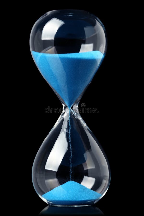 Hourglass With Blue Sand On A Blurred Black And White Background Sand Trending Color Stock
