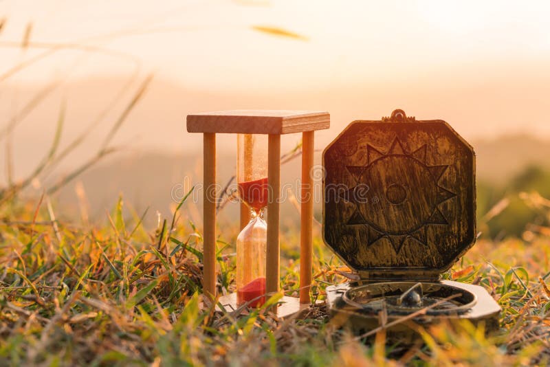 Hourglass and Compass with Sunrise in the Morning at Mountain Stock ...