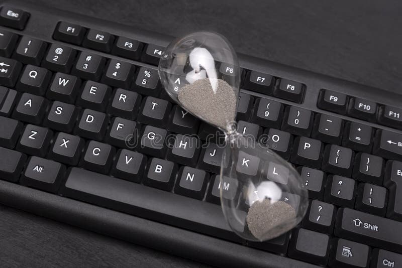 Hourglass on Computer Keyboard. Time Management Concept Stock Photo ...