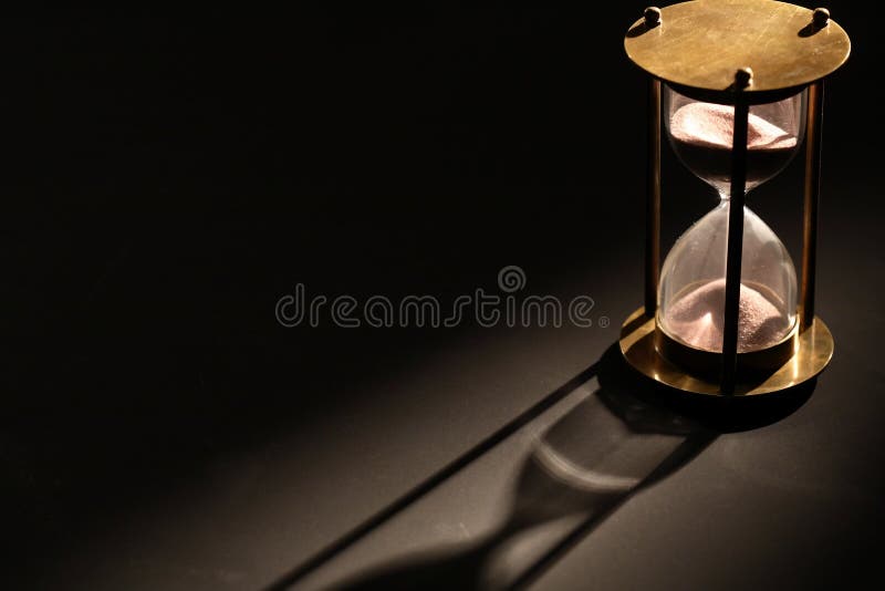 Hourglass on Dark stock photo. Image of flowing, time - 81153590