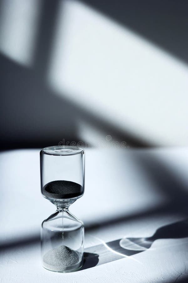 Hourglass on the Desk Striking Light, Shadow and Glass Reflections ...