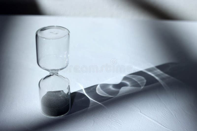Hourglass on the Desk Striking Light, Shadow and Glass Reflections ...