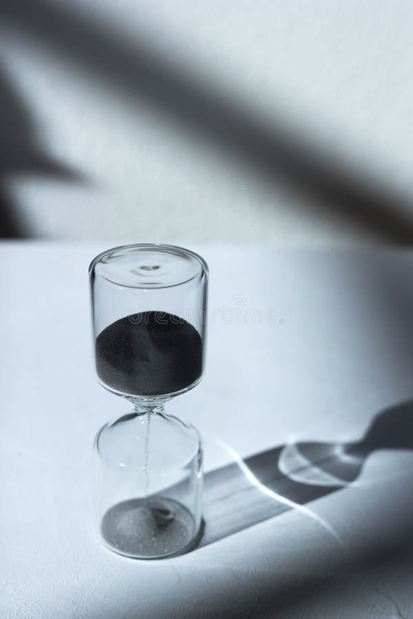 Hourglass on the Desk Striking Light, Shadow and Glass Reflections ...