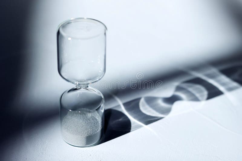 Hourglass on the Desk Striking Light, Shadow and Glass Reflections ...