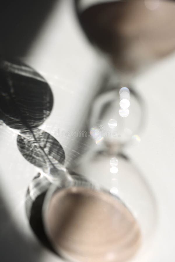 Hourglass on the Desk Striking Light, Shadow and Glass Reflections ...