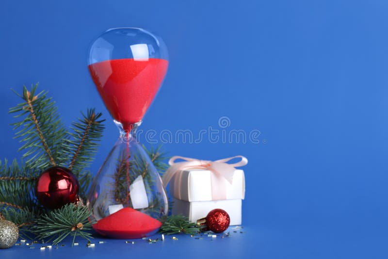 Hourglass, Gift, Fir Tree Branches with Decor on Blue, Space for Text ...