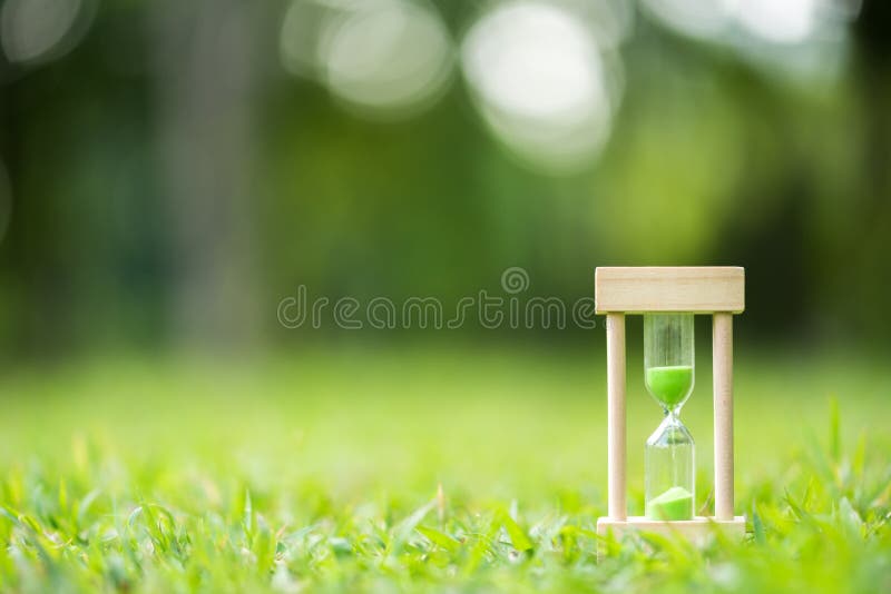 Hourglass on Green Grass Field , Spring Time Stock Image - Image of ...