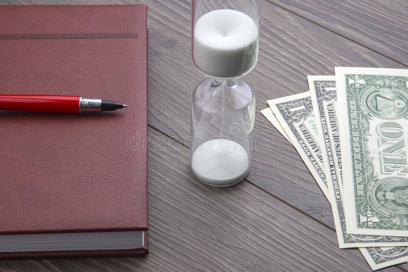 Hourglass, Money, Pen and Notebook are on the Table. Business Office ...