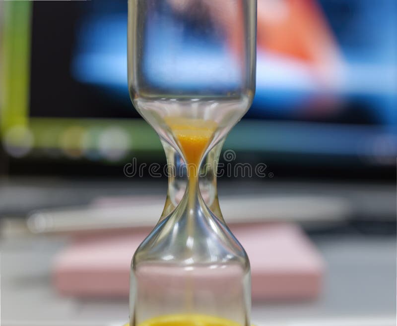 Hourglass in the Office on the Background of a Computer, the Last ...