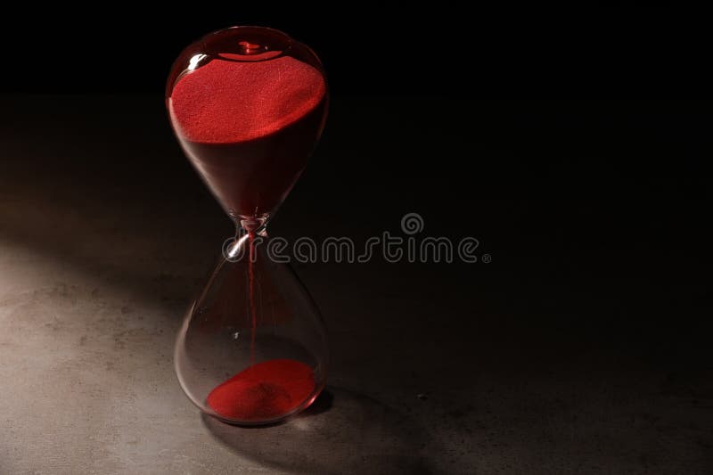 Hourglass with Red Flowing Sand on Grey Table. Space for Text Stock ...