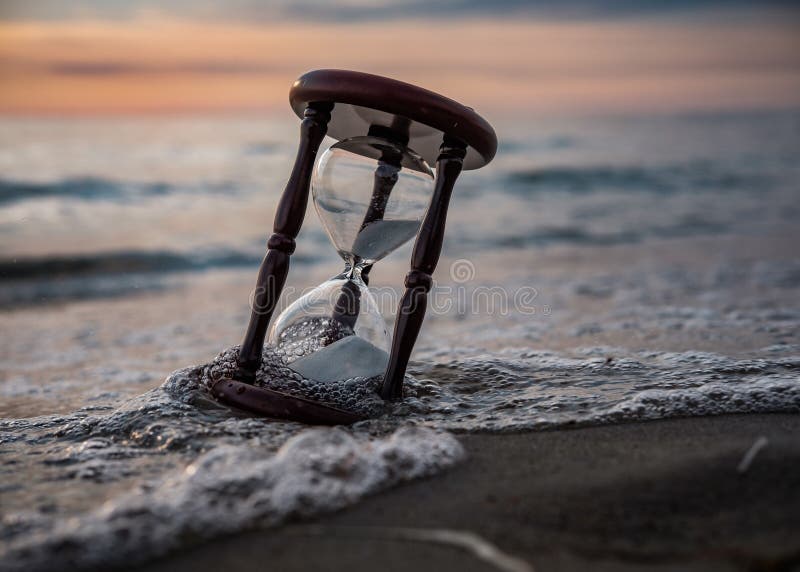 A Hourglass Standing On The Sand By The Beach At Sunset Stock Image Image Of Horizon Hues