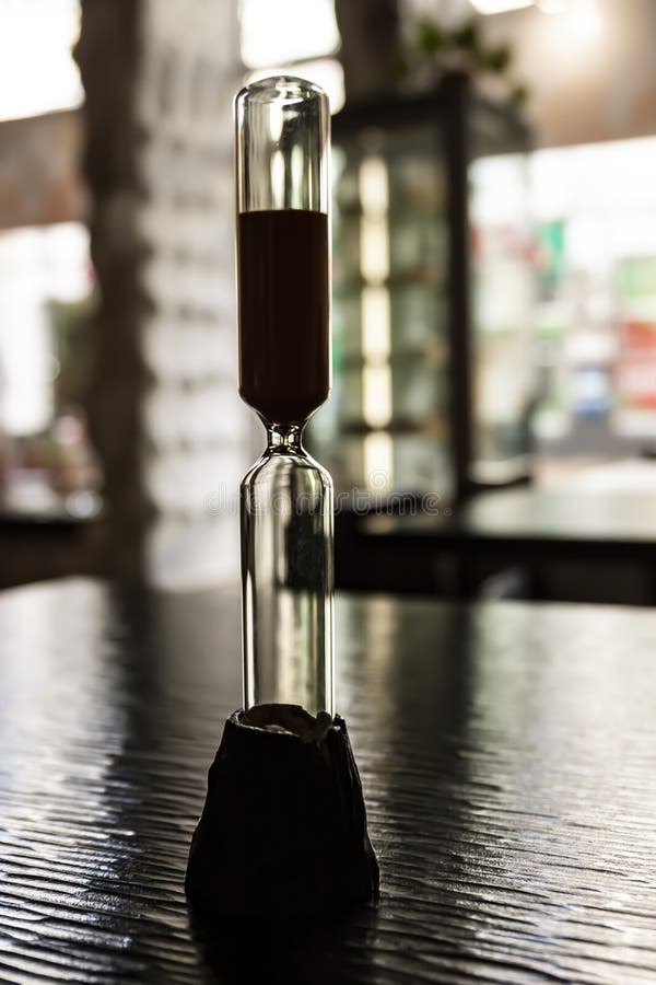 Hourglass on the Table in Cafe on Wooden Working Table with Morning ...