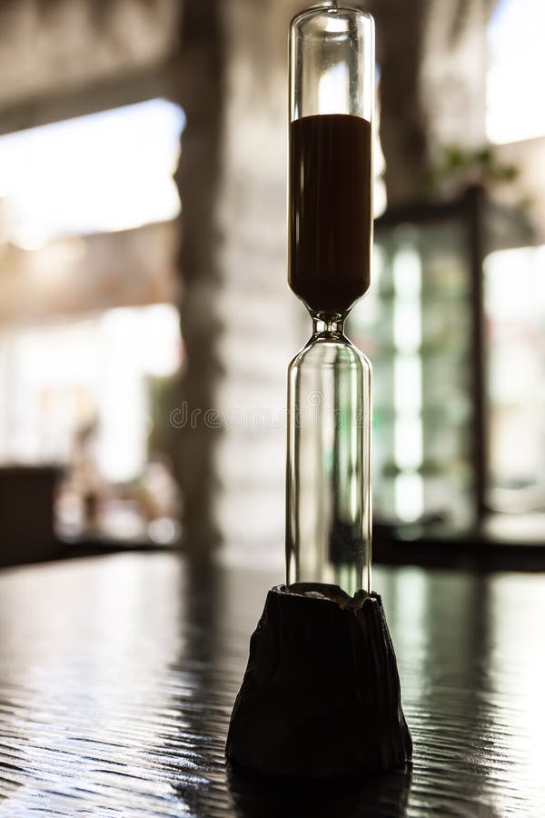 Hourglass on the Table in Cafe on Wooden Working Table with Morning ...