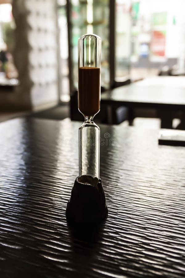 Hourglass on the Table in Cafe on Wooden Working Table with Morning ...