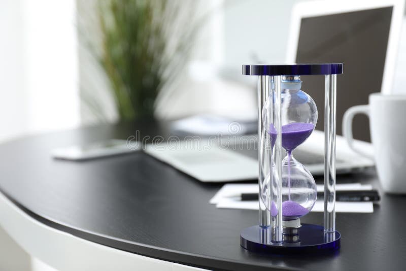 Hourglass on Table in Office. Time Management Concept Stock Image ...