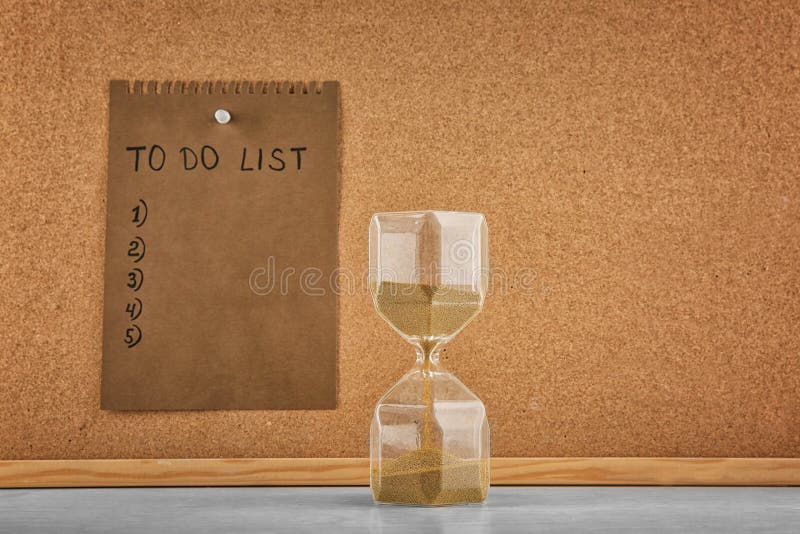 Hourglass on Table and Sheet of Paper with To-do List on Board. Time ...