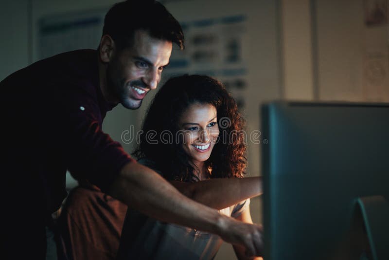 The Hours are Worth the Rewards. Two Colleagues Using a Computer ...