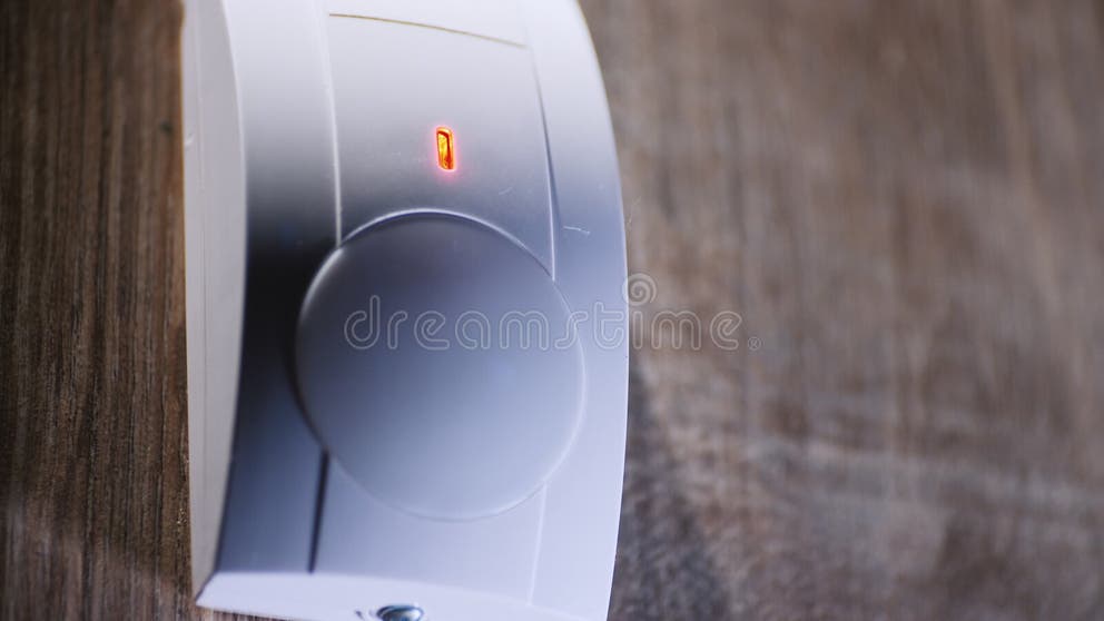 The House Alarm is on the Wall. the Red Motion Sensor Trigger is Lit ...