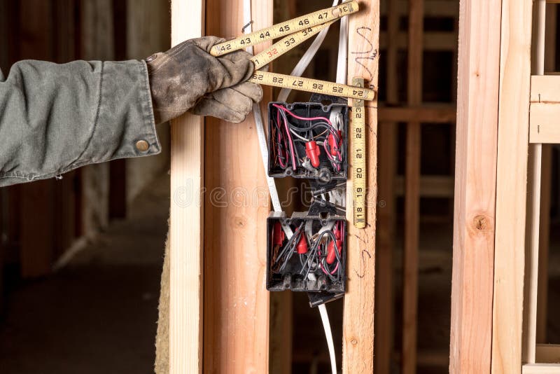 House Builder Uses an Old Wooden Ruler To Measure Electrical Box Stock ...
