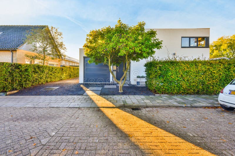 A House with a Driveway and a Tree in Front Editorial Photo - Image of ...