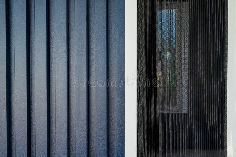 House with a Facade Covered with Dark Blue PVC Panels and Fly Screen ...