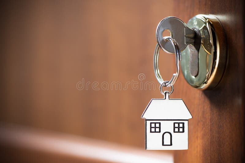 House key in the door stock photo. Image of estate, house - 140611278