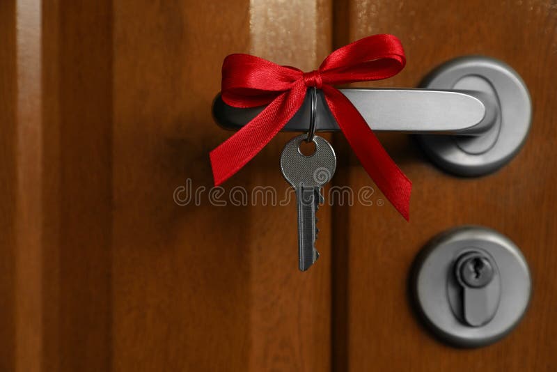 House Key with Red Bow on Door Handle, Closeup. Housewarming Party ...