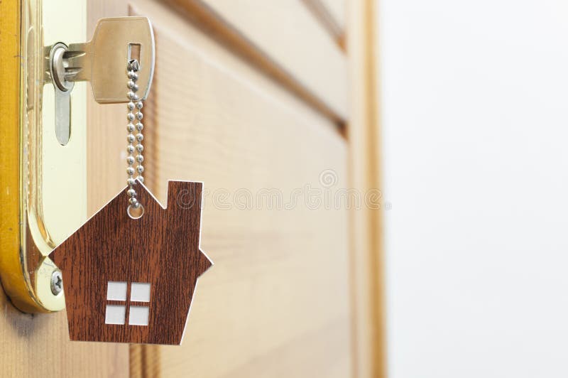 House Key on a House Shaped Silver Keyring in the Lock of a Door Stock ...