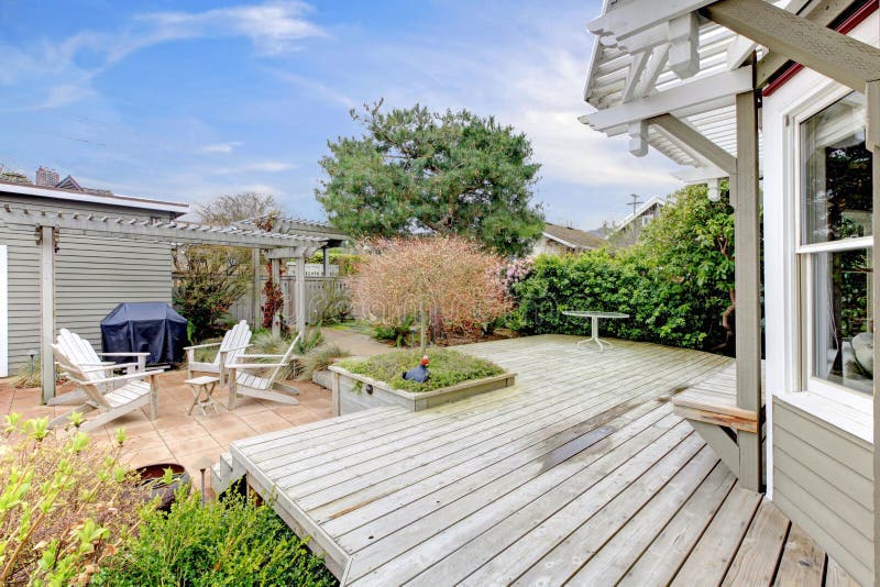 House Spring Backyard with Rock Wall and Kids Playground. Stock Photo ...