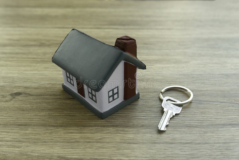 House Model with Key on Wooden Surface - Real Estate Concept Stock ...