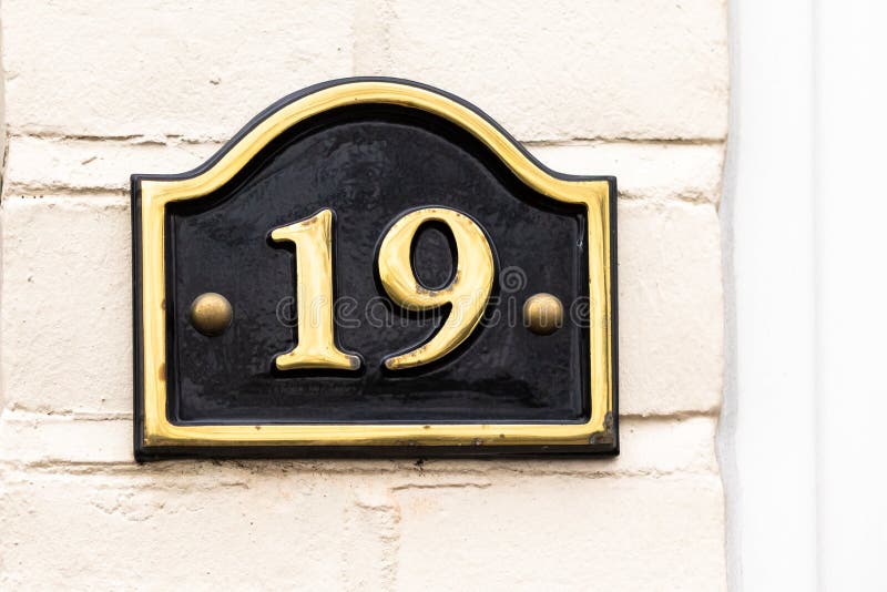 House Number 47 on a White Plaque on a Dark Green Wooden Front Door ...