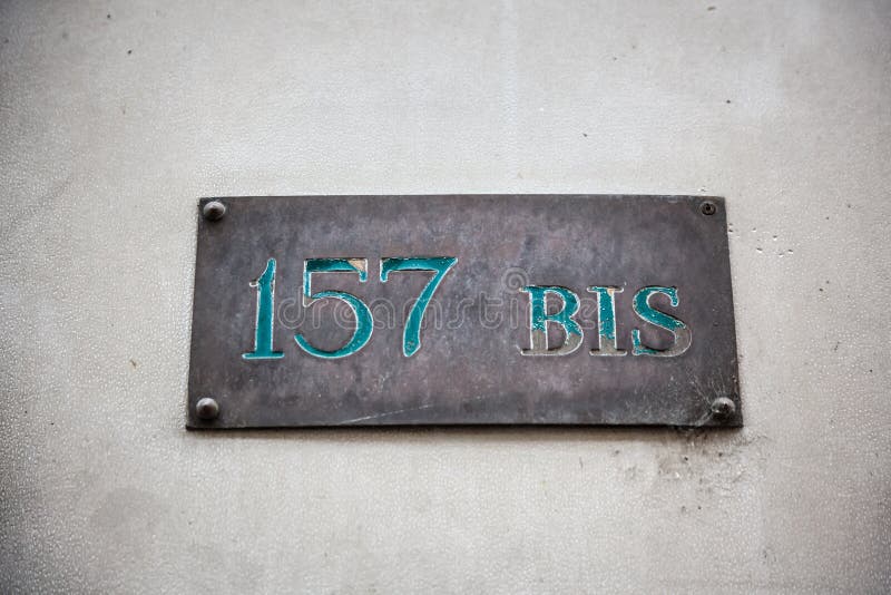 House Number 47 on a White Plaque on a Dark Green Wooden Front Door ...
