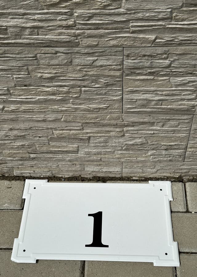 House Number Plate Next To the Wall of a Building Stock Image - Image ...