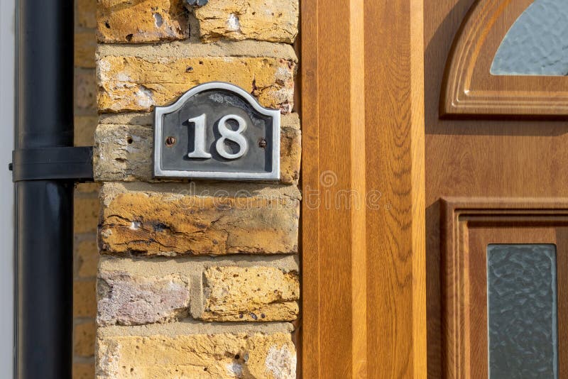 House Number 47 on a White Plaque on a Dark Green Wooden Front Door ...
