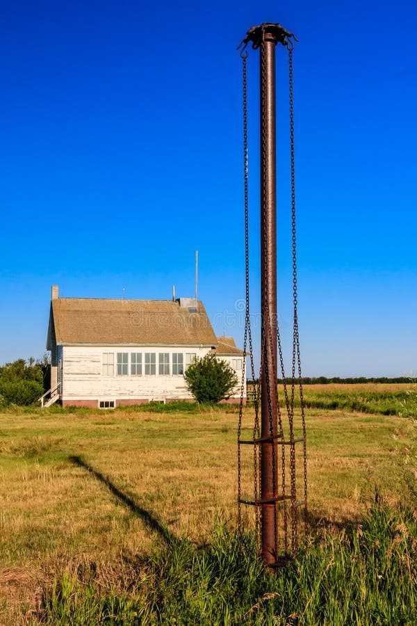 A House and a Pole with Chains Hanging from it Stock Image - Image of ...